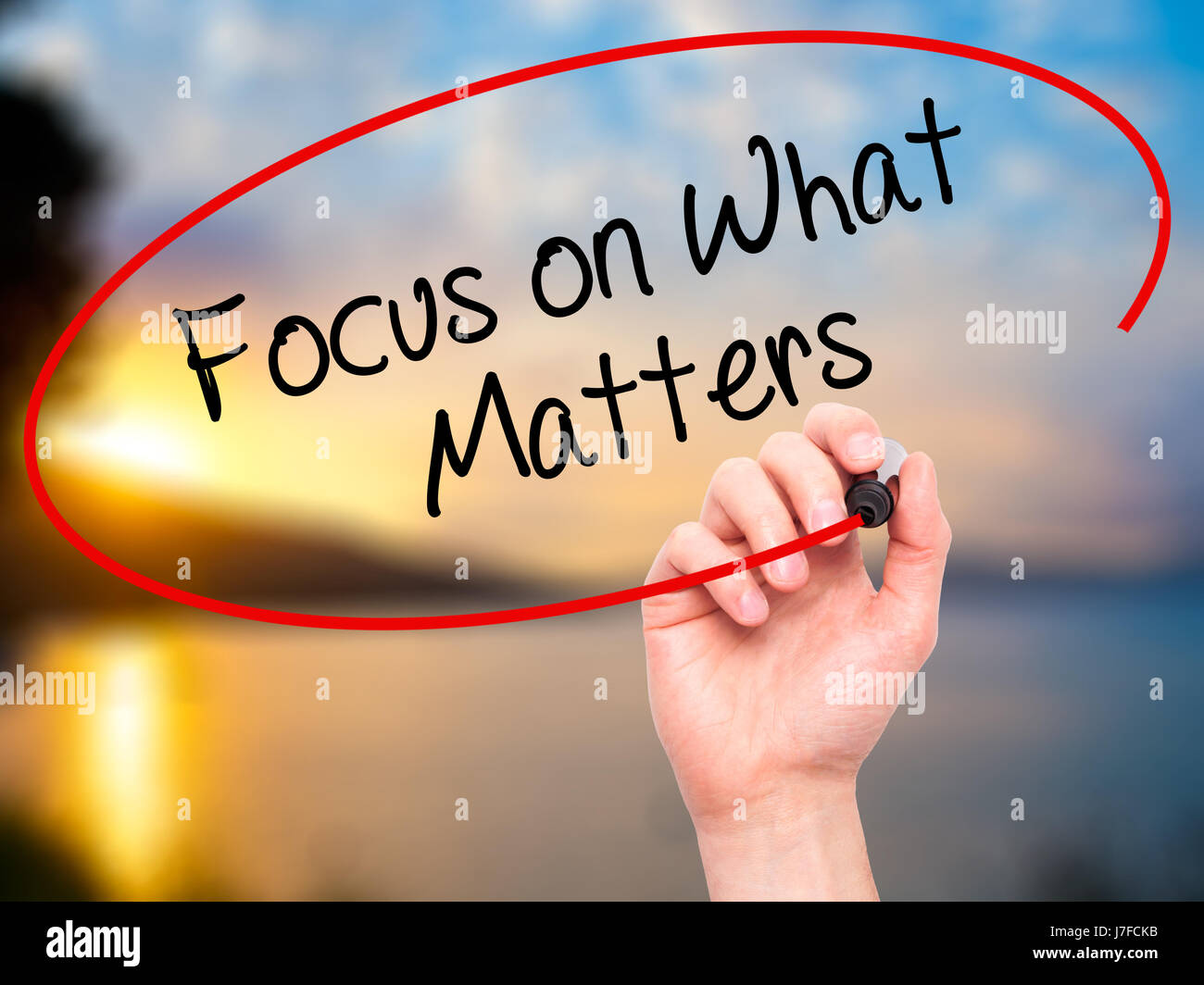 Man Hand writing Focus on What Matters with black marker on visual ...