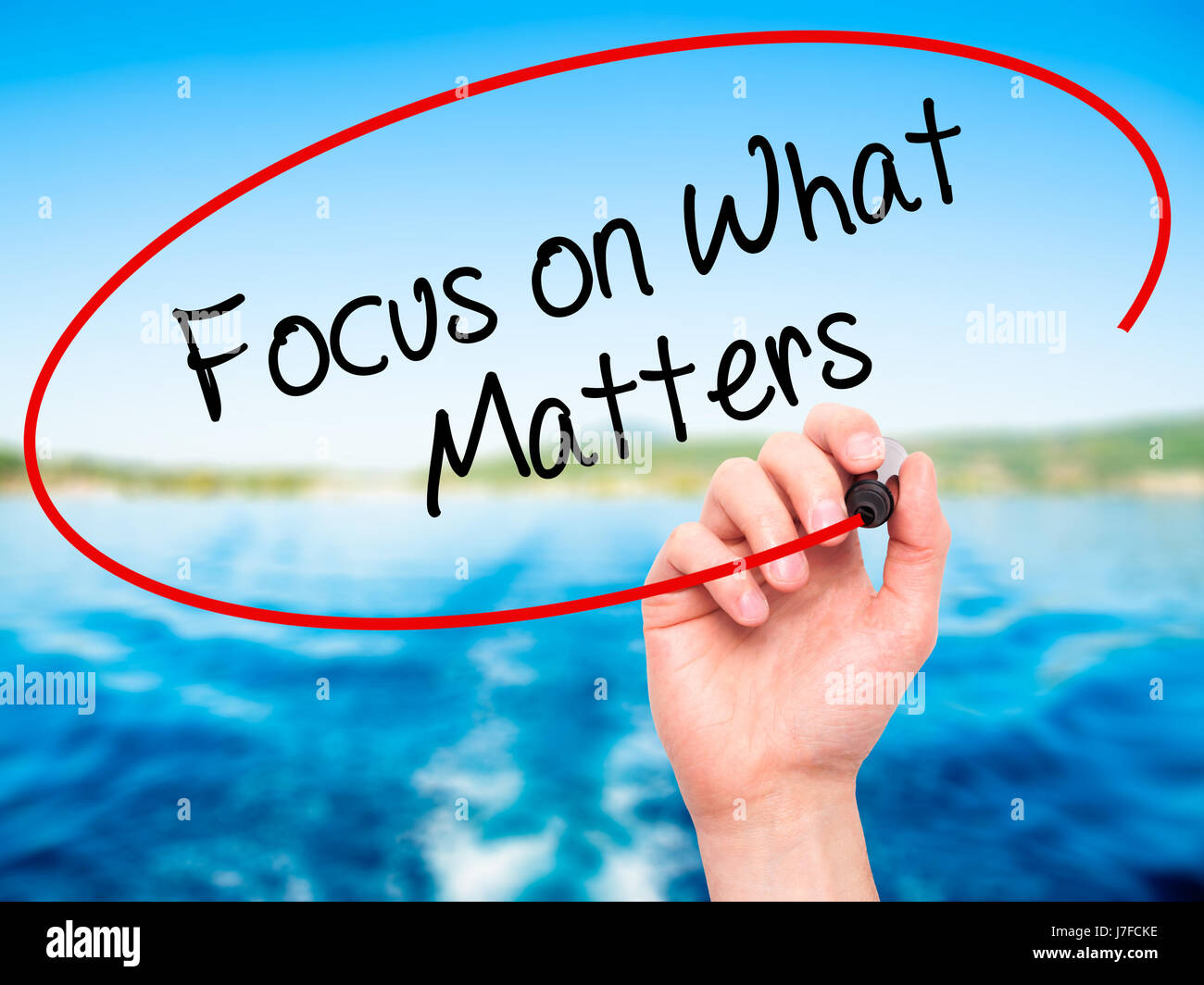 Man Hand writing Focus on What Matters with black marker on visual ...