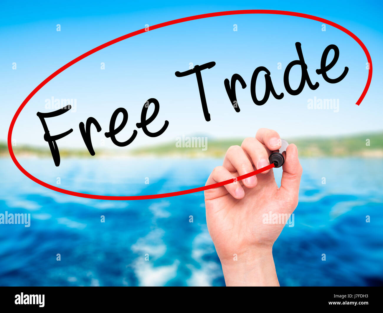 Man Hand writing Free Trade with black marker on visual screen ...