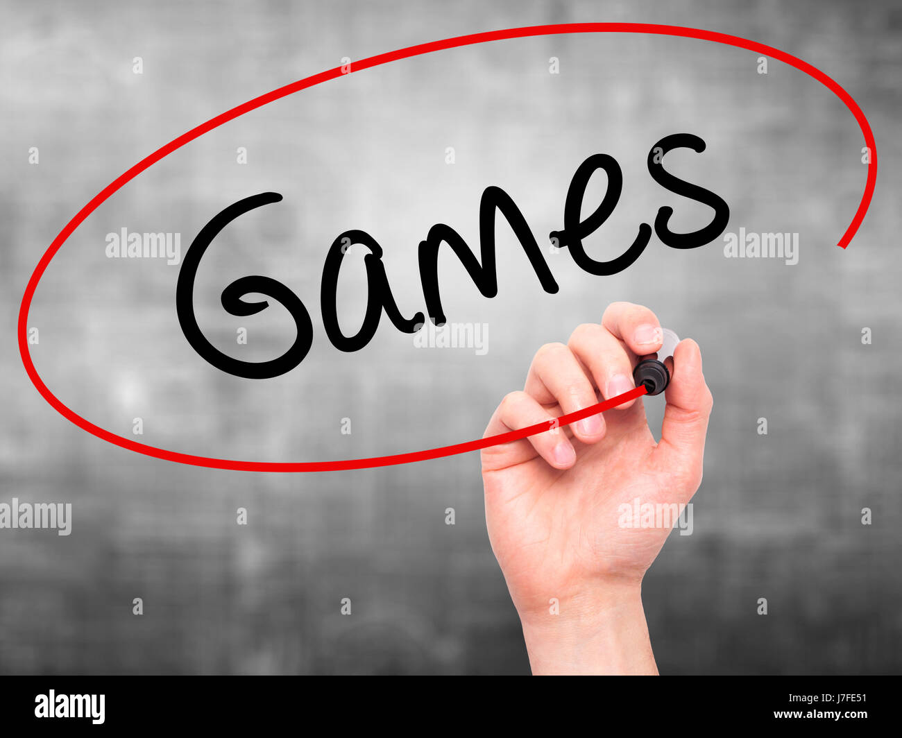 Man Hand writing Games with black marker on visual screen. Isolated on ...