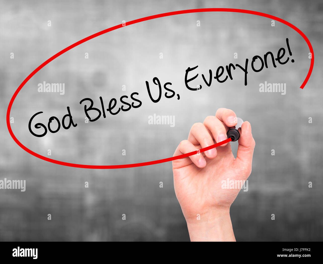 Man Hand writing God Bless Us, Everyone! with black marker on visual ...