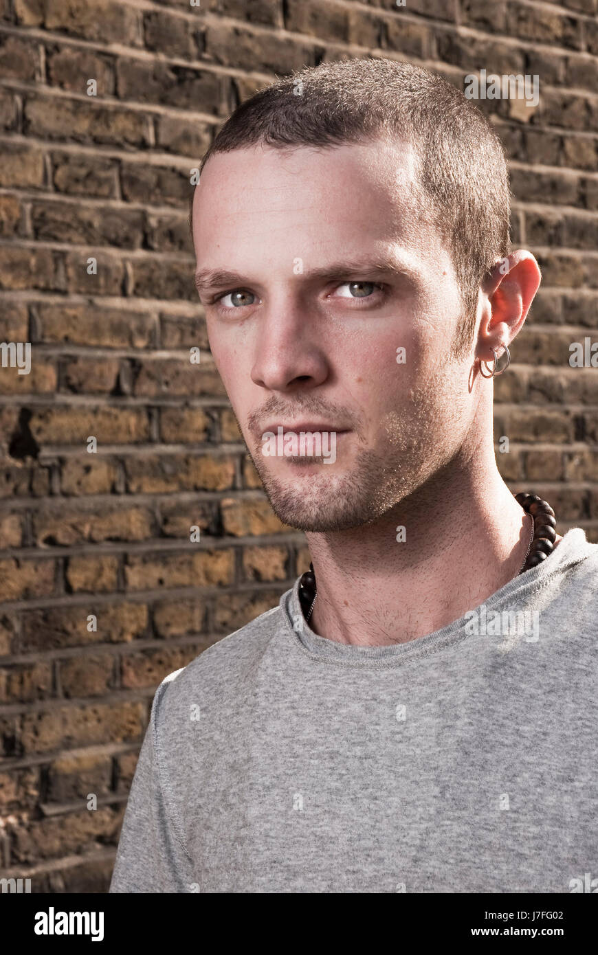 face portrait wall studio outdoor outside adult brick stare serious ...