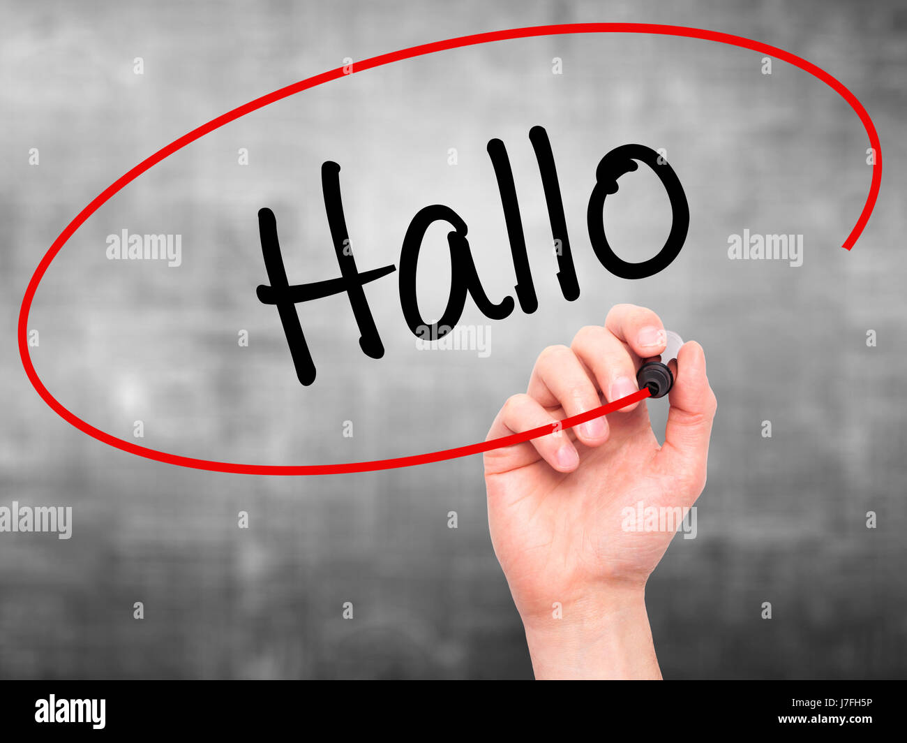 Man Hand writing Hallo (Hello in German) with black marker on visual ...