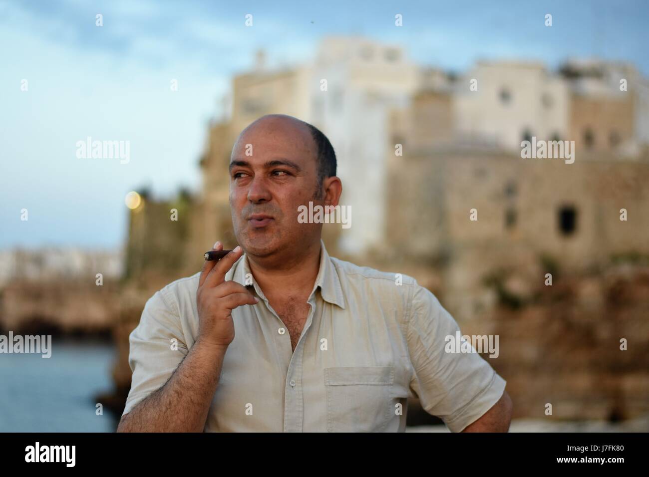 A man smoking , Polignano a Mare, Apulia, Italy Stock Photo - Alamy