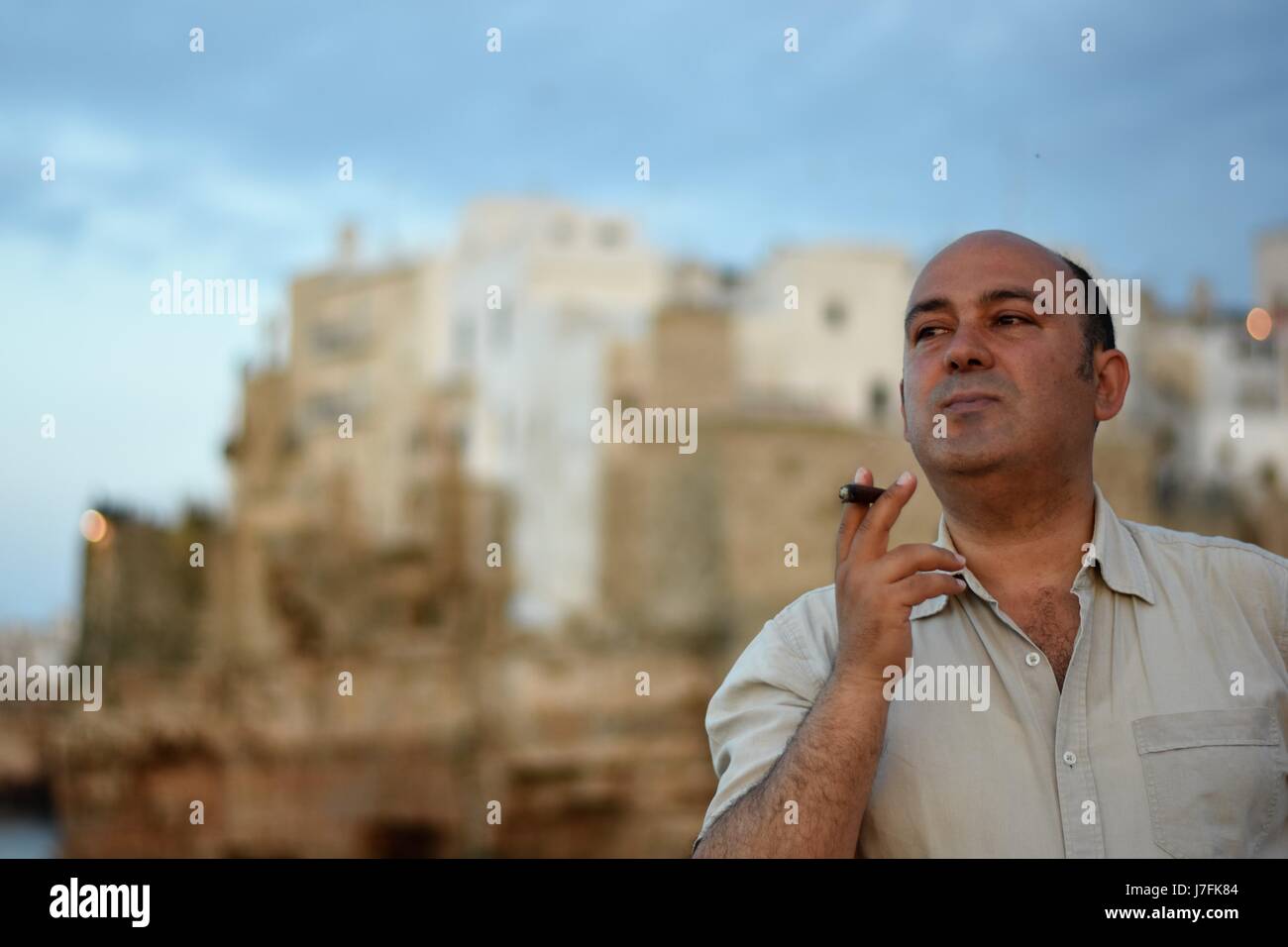 A man smoking , Polignano a Mare, Apulia, Italy Stock Photo - Alamy