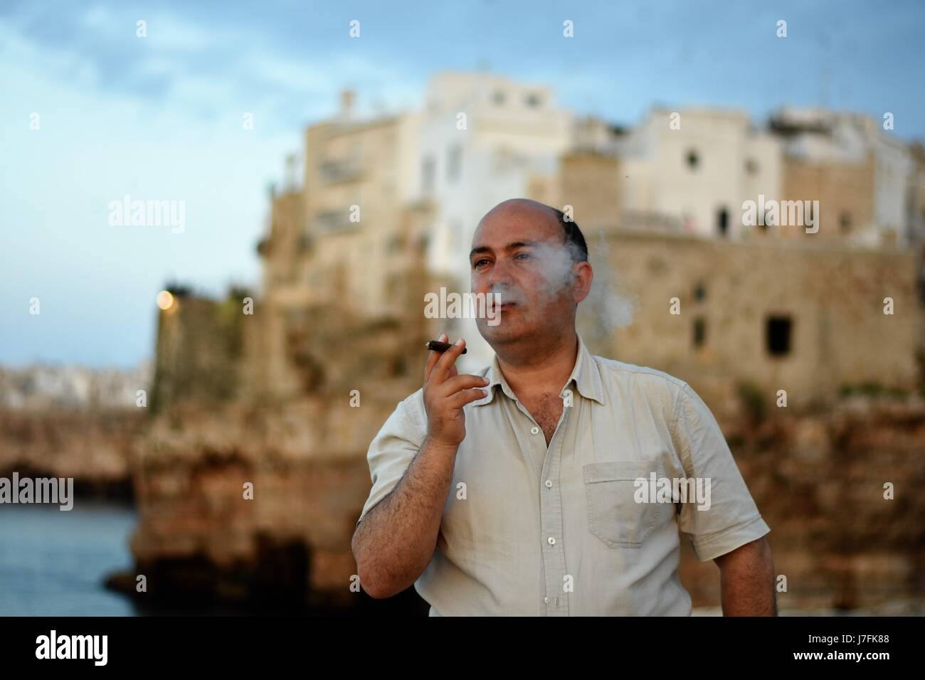 A man smoking , Polignano a Mare, Apulia, Italy Stock Photo - Alamy
