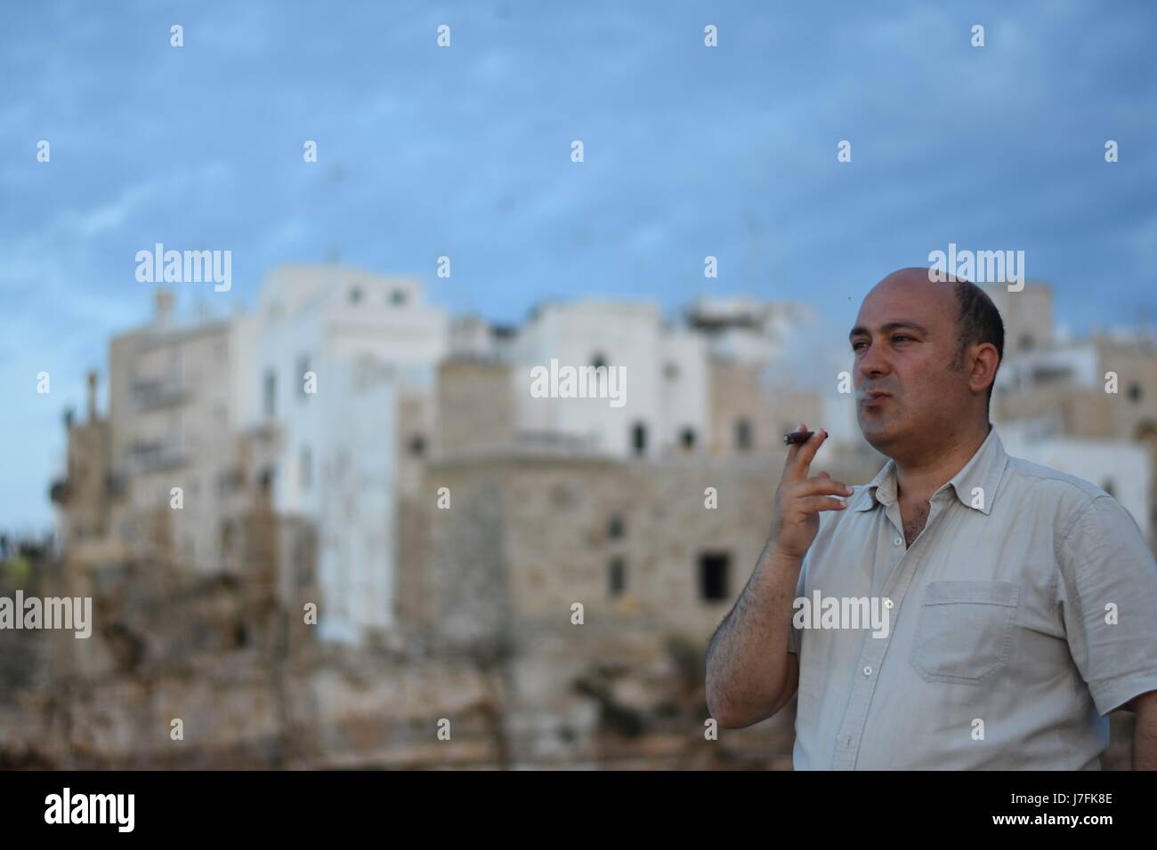 A man smoking , Polignano a Mare, Apulia, Italy Stock Photo - Alamy