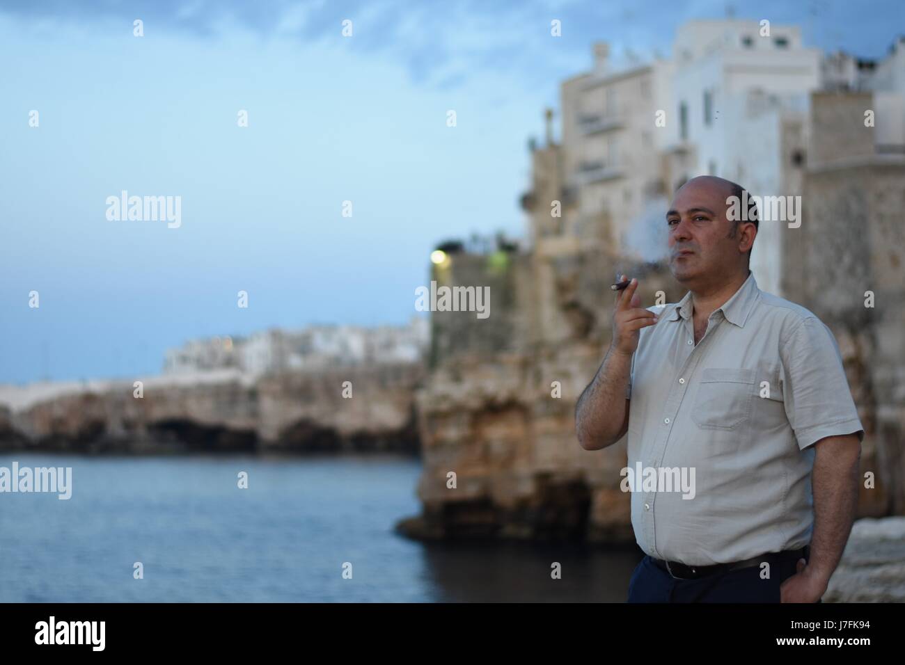 A man smoking , Polignano a Mare, Apulia, Italy Stock Photo - Alamy
