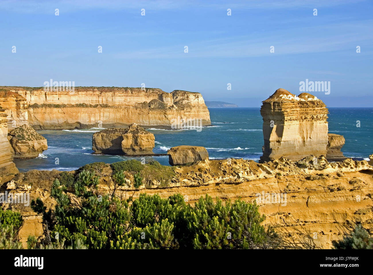 blue stone beach seaside the beach seashore waves formation bushes rock ...