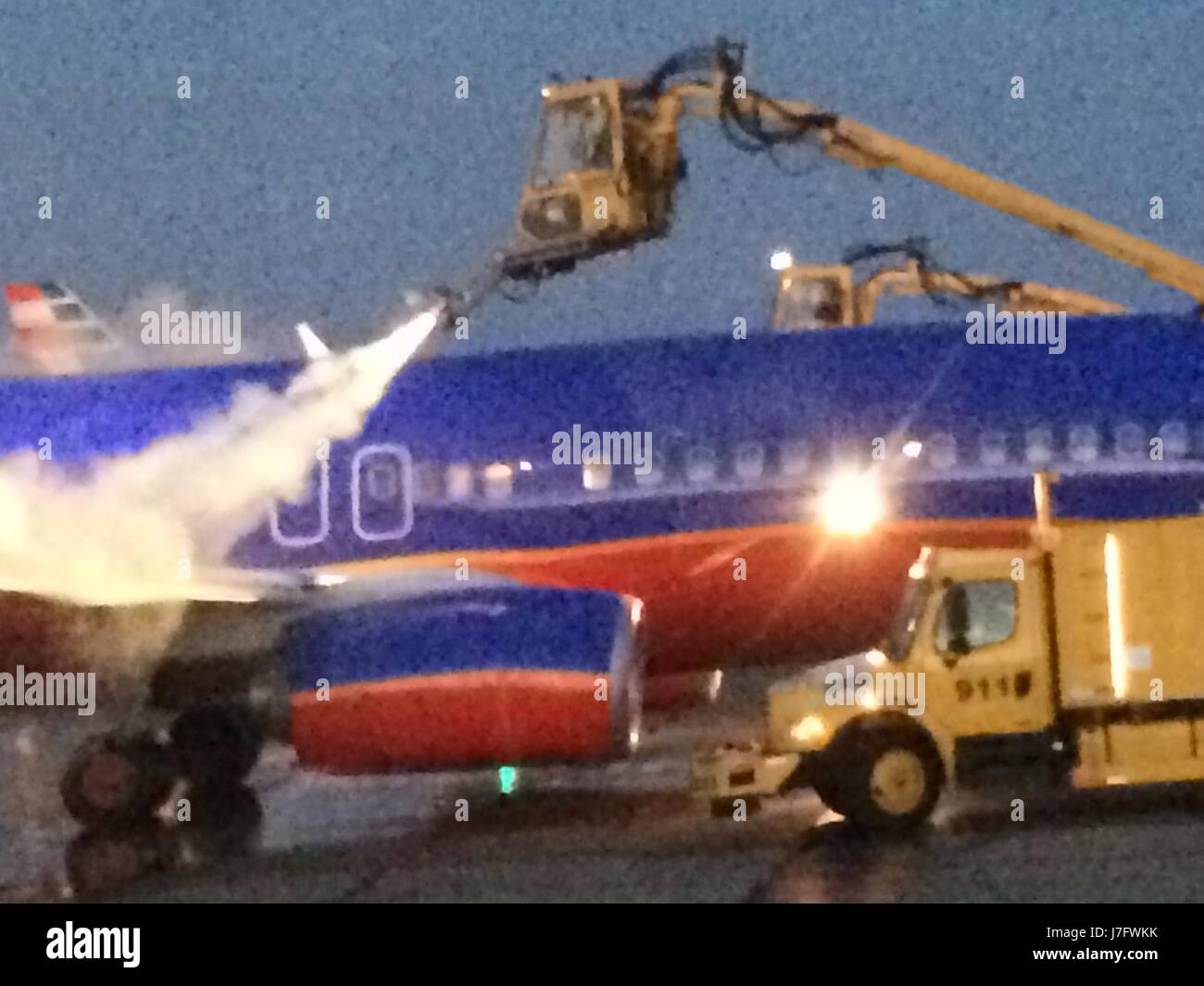 Aircraft being de-iced in bad weather Stock Photo - Alamy