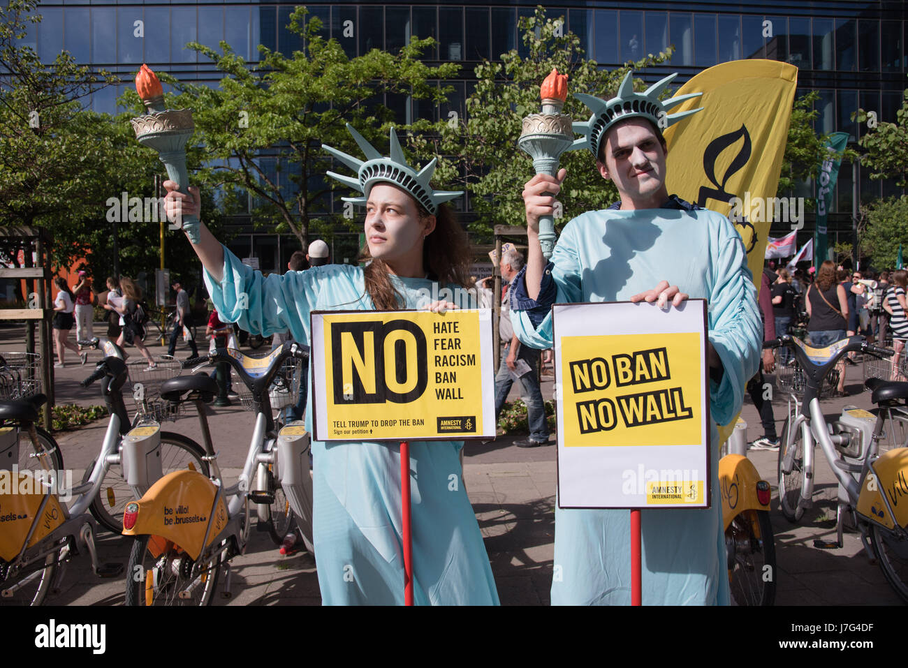 Protesters dressed as the statue of liberty pose for a picture at the ...