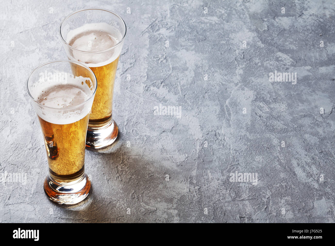 Lager beer glasses on stone table. With copy space Stock Photo - Alamy