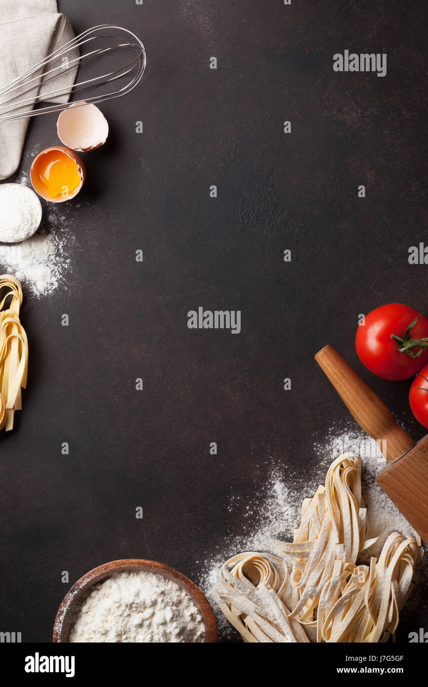 Pasta cooking ingredients on wooden kitchen table. Top view with space ...