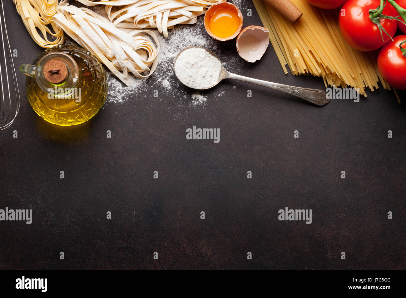 Pasta cooking ingredients on wooden kitchen table. Top view with space ...