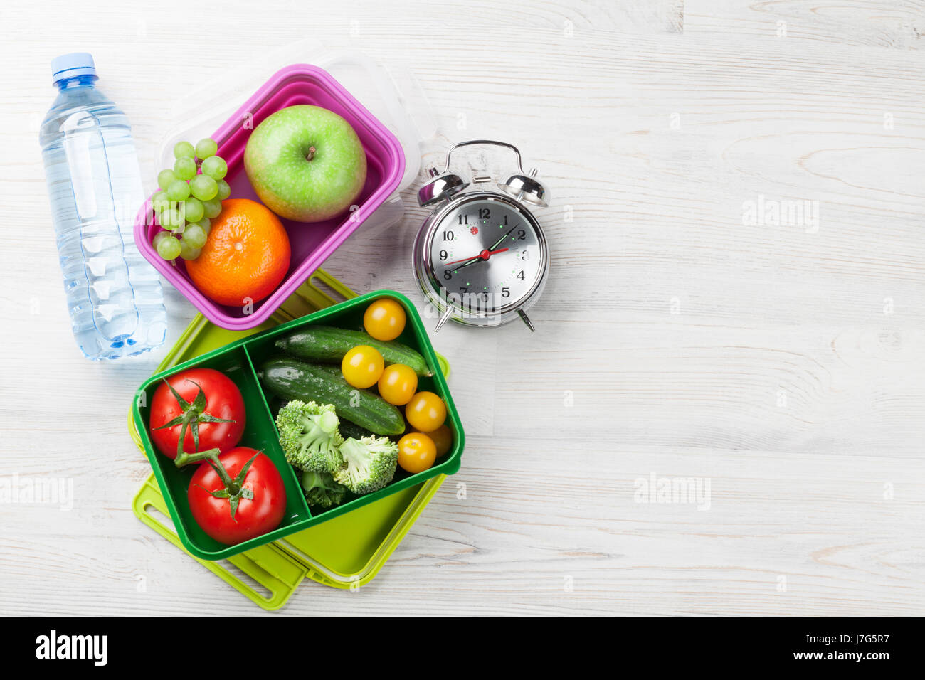 Lunch box with vegetable and fruits on wooden table. Top view with copy ...