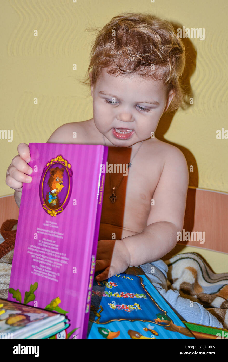 The little girl thumbed children's books Stock Photo - Alamy