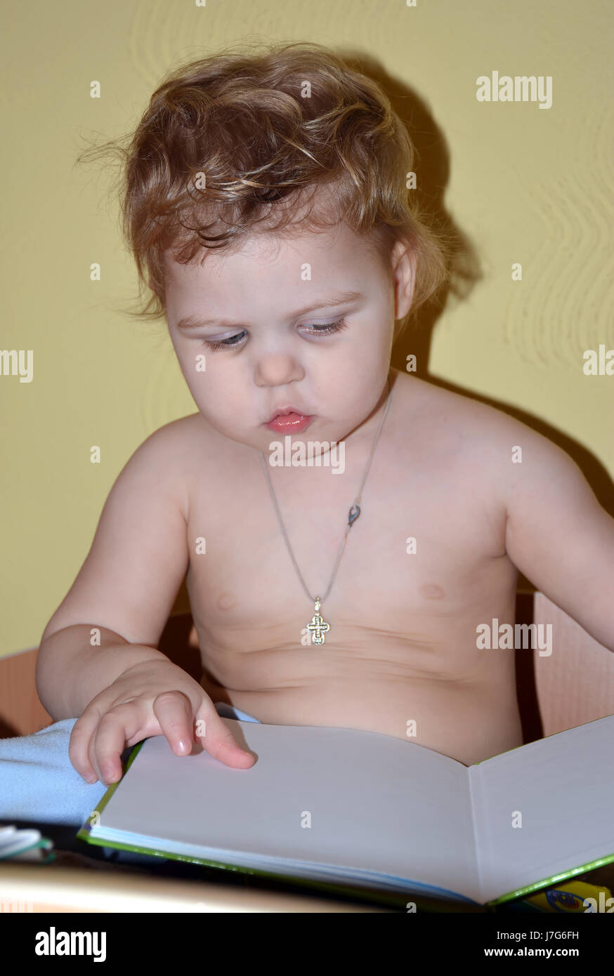 The little girl thumbed children's books Stock Photo - Alamy