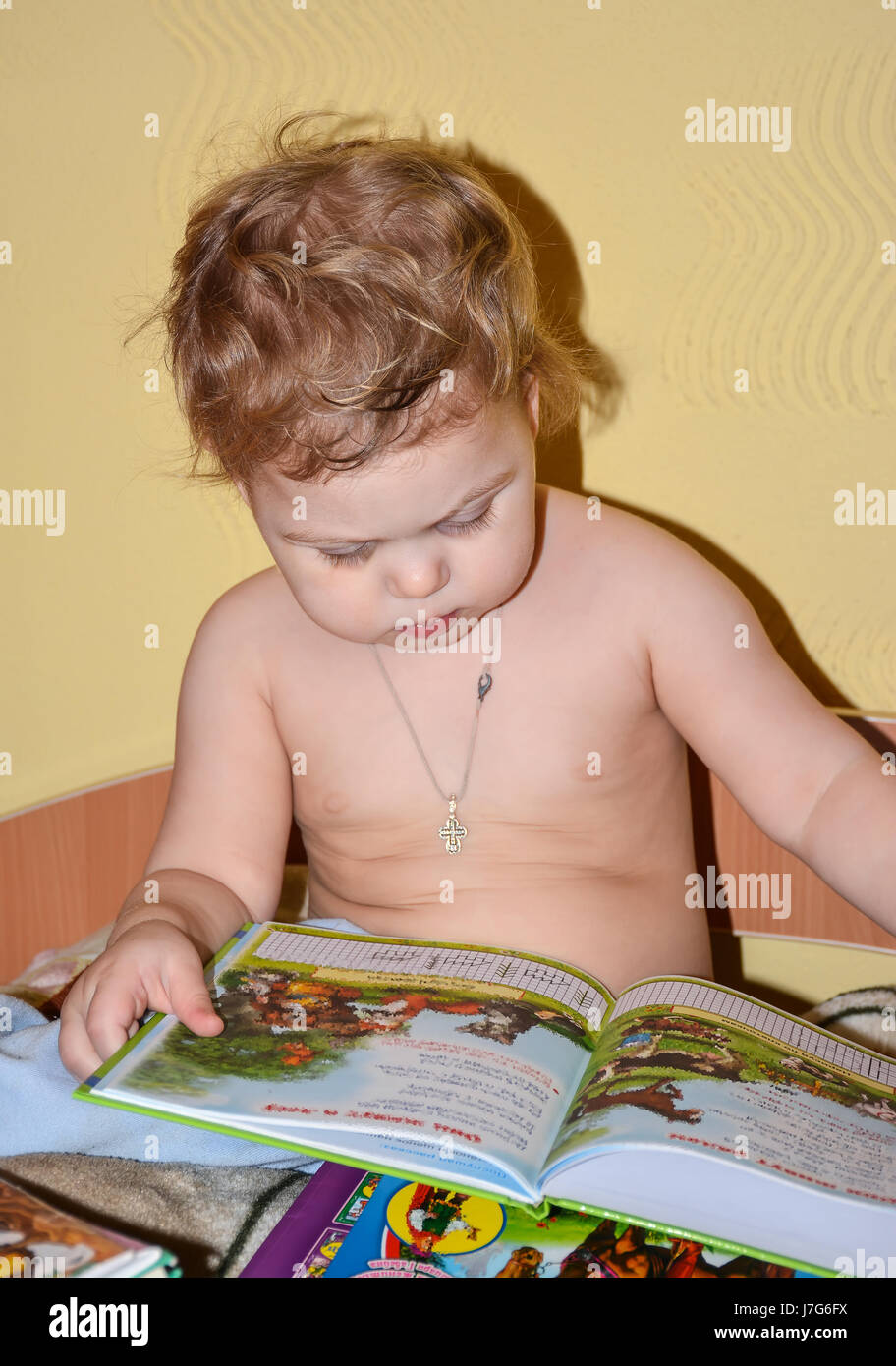The little girl thumbed children's books Stock Photo - Alamy