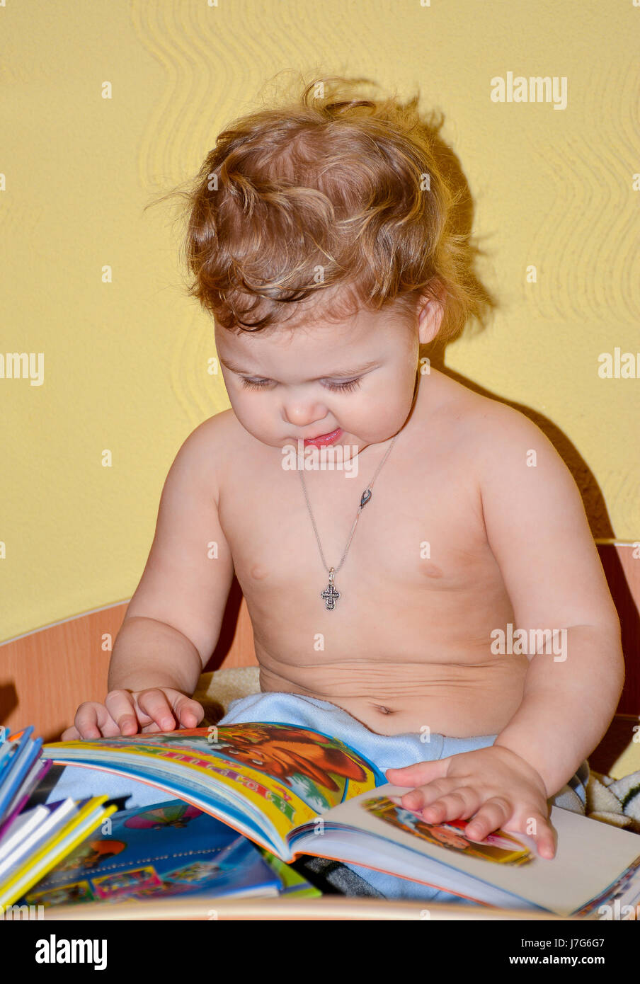 The little girl thumbed children's books Stock Photo - Alamy