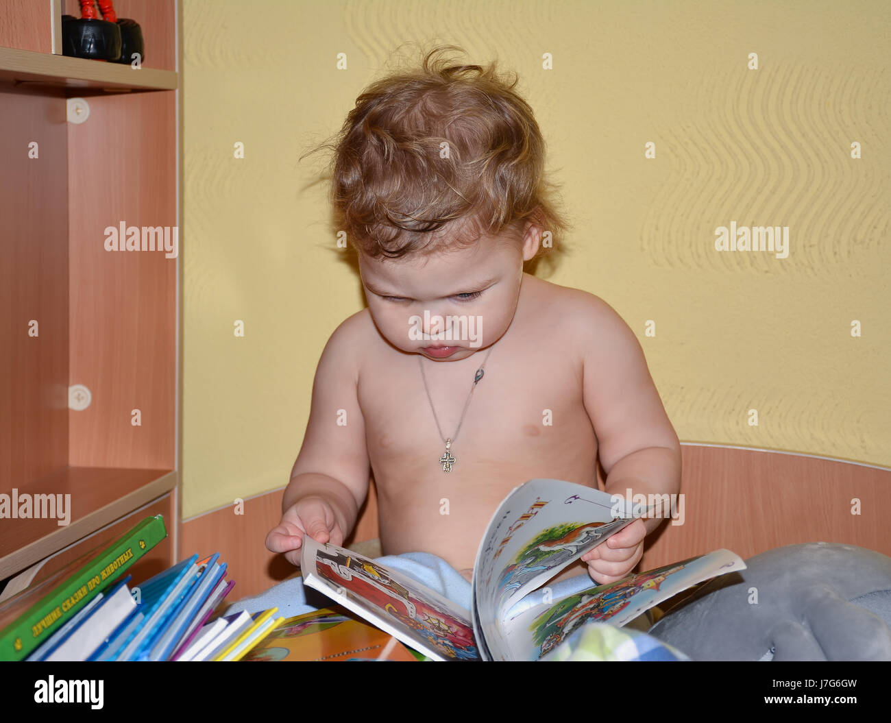 The little girl thumbed children's books Stock Photo - Alamy