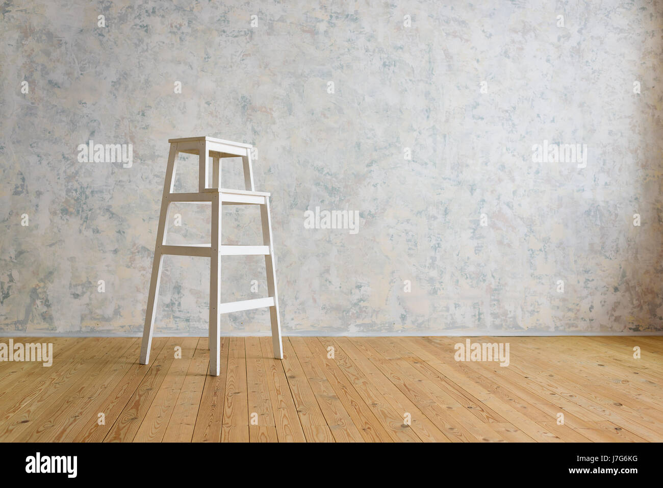 wooden staircase stands in a room with a white wall Stock Photo - Alamy