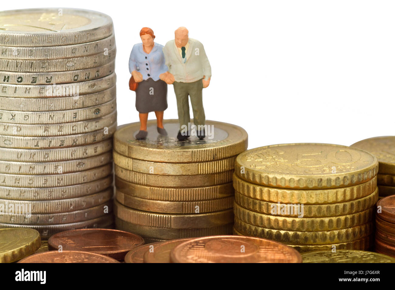 Figurine from senior couple with eruo coins on white background Stock ...