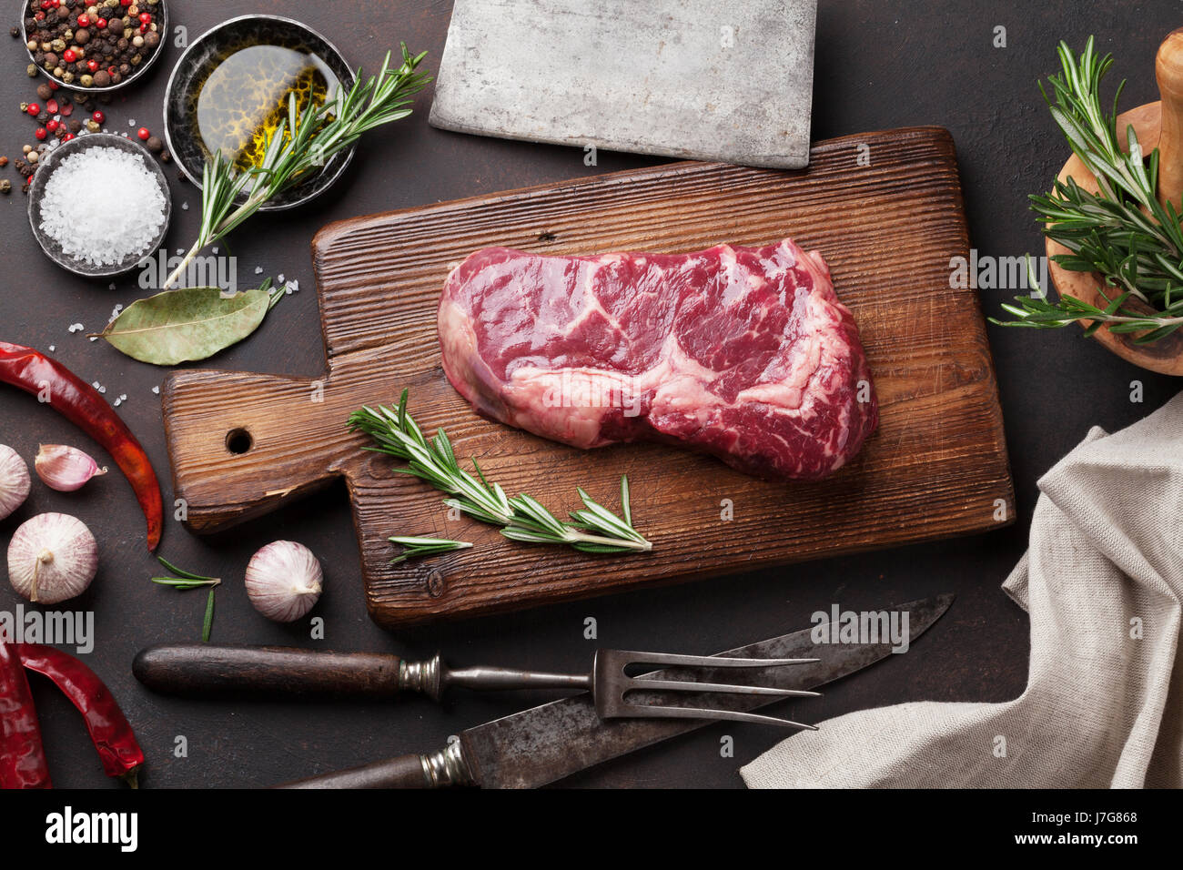Raw ribeye beef steak cooking with ingredients. Top view Stock Photo ...