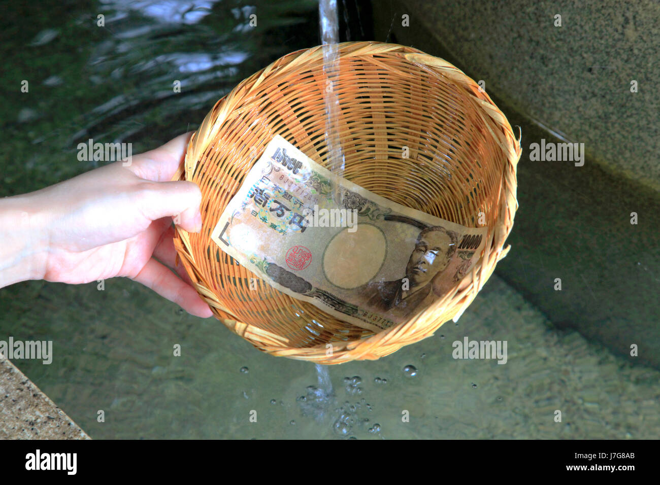 Washing Money with Purifying Water in Mount Takao Yakuoin Temple in ...