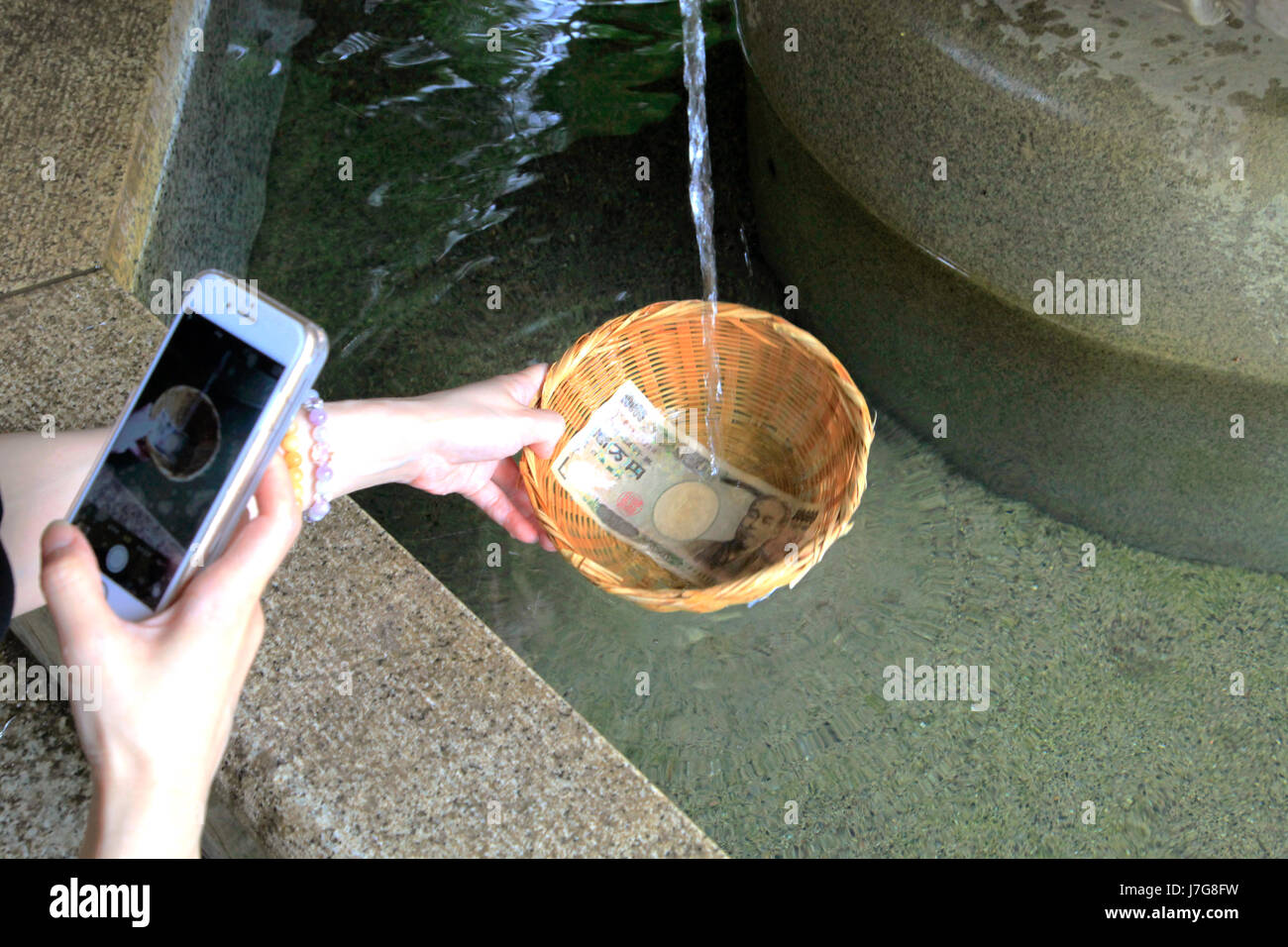 Washing Money with Purifying Water in Mount Takao Yakuoin Temple in ...