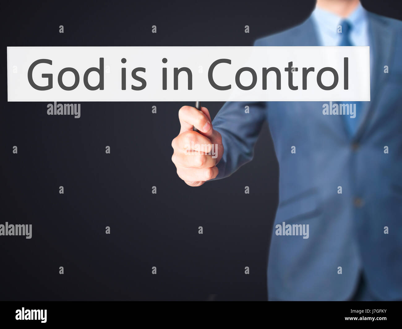 God is in Control - Businessman hand holding sign. Business, technology ...