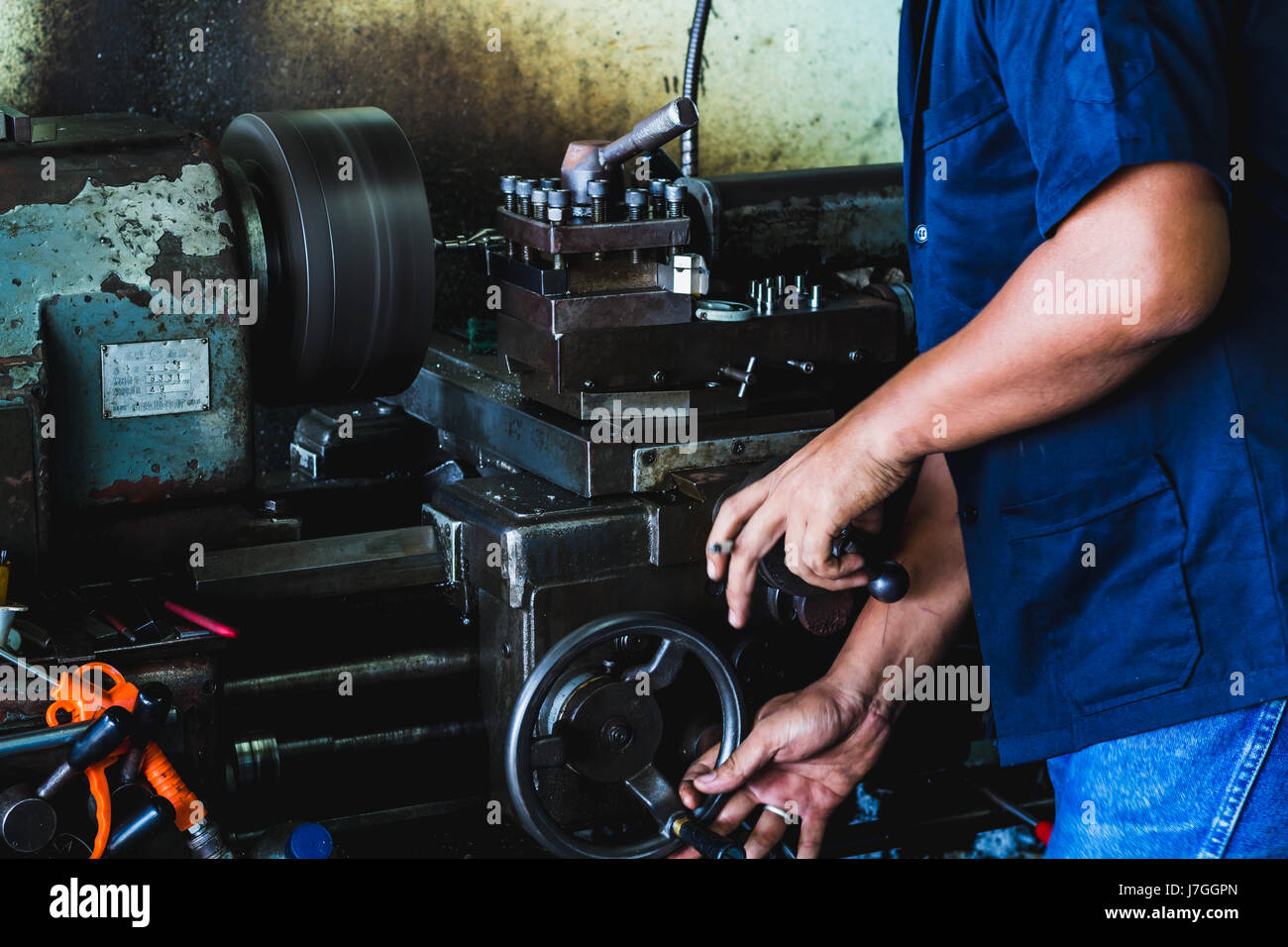worker use lathe machine to product in workshop for industry concept ...