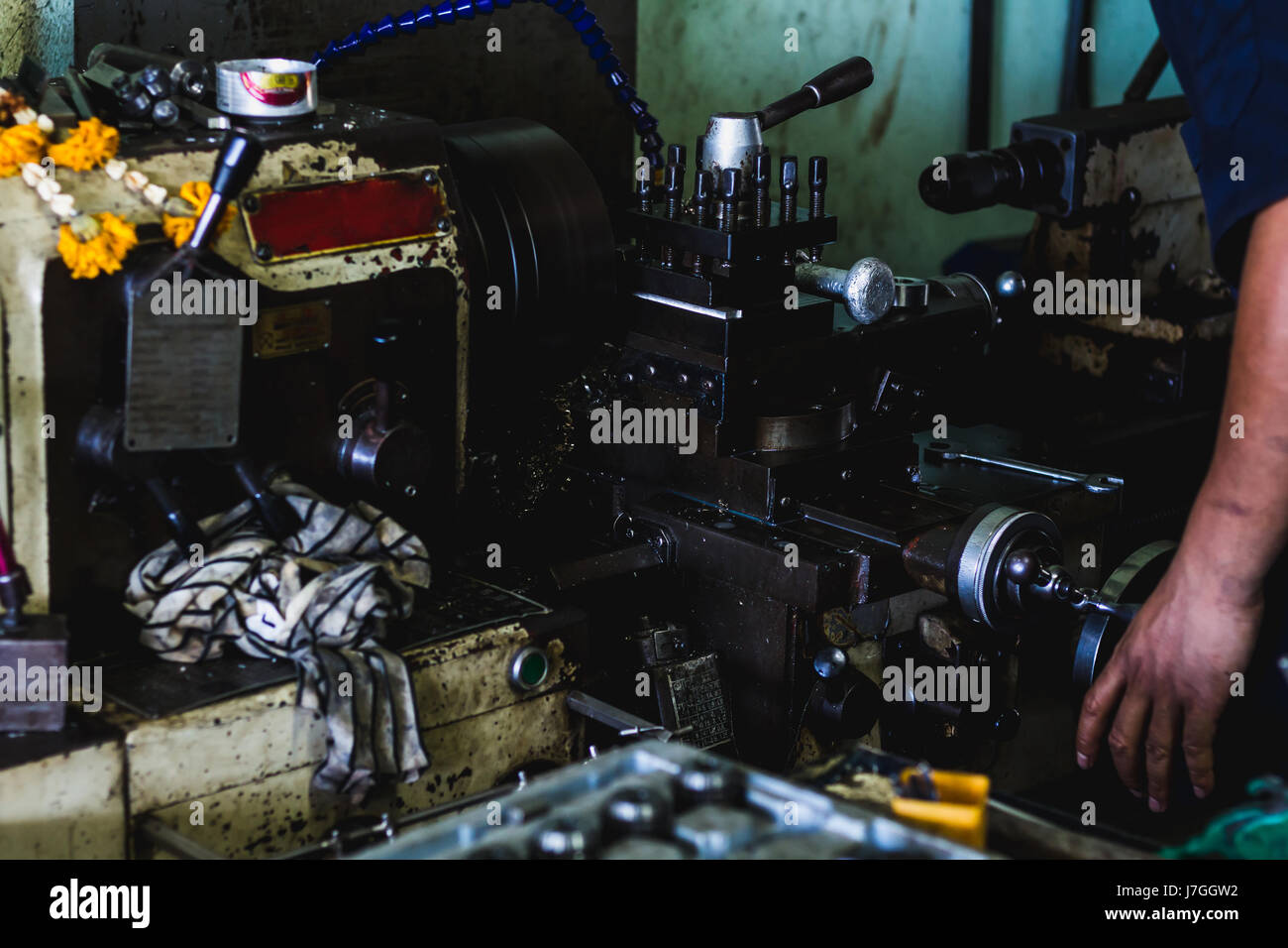 worker use lathe machine to product in workshop for industry concept ...