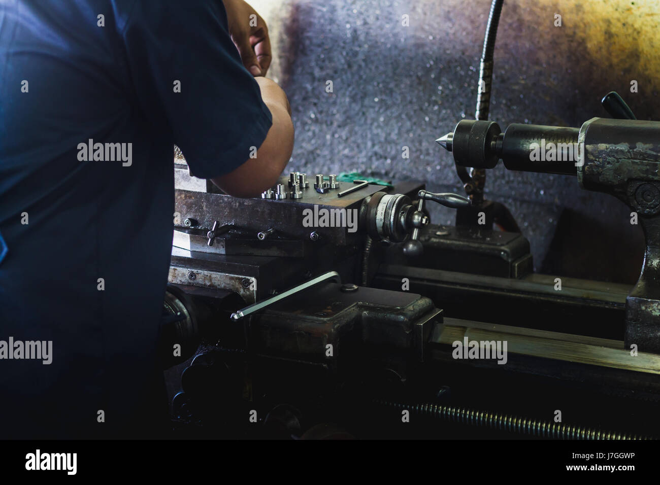 worker use lathe machine to product in workshop for industry concept ...