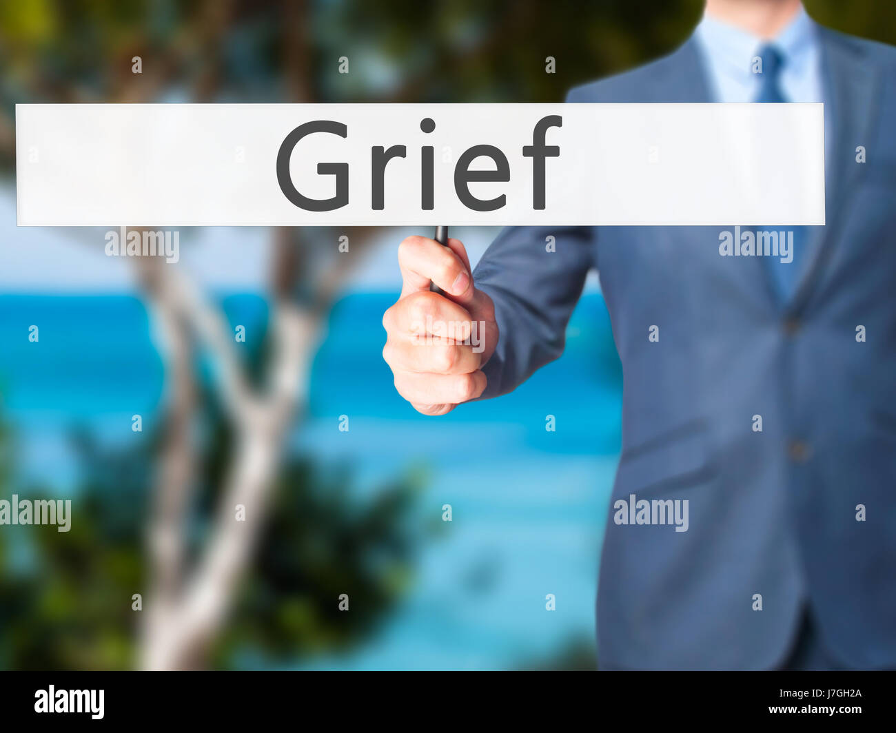 Grief - Businessman hand holding sign. Business, technology, internet ...