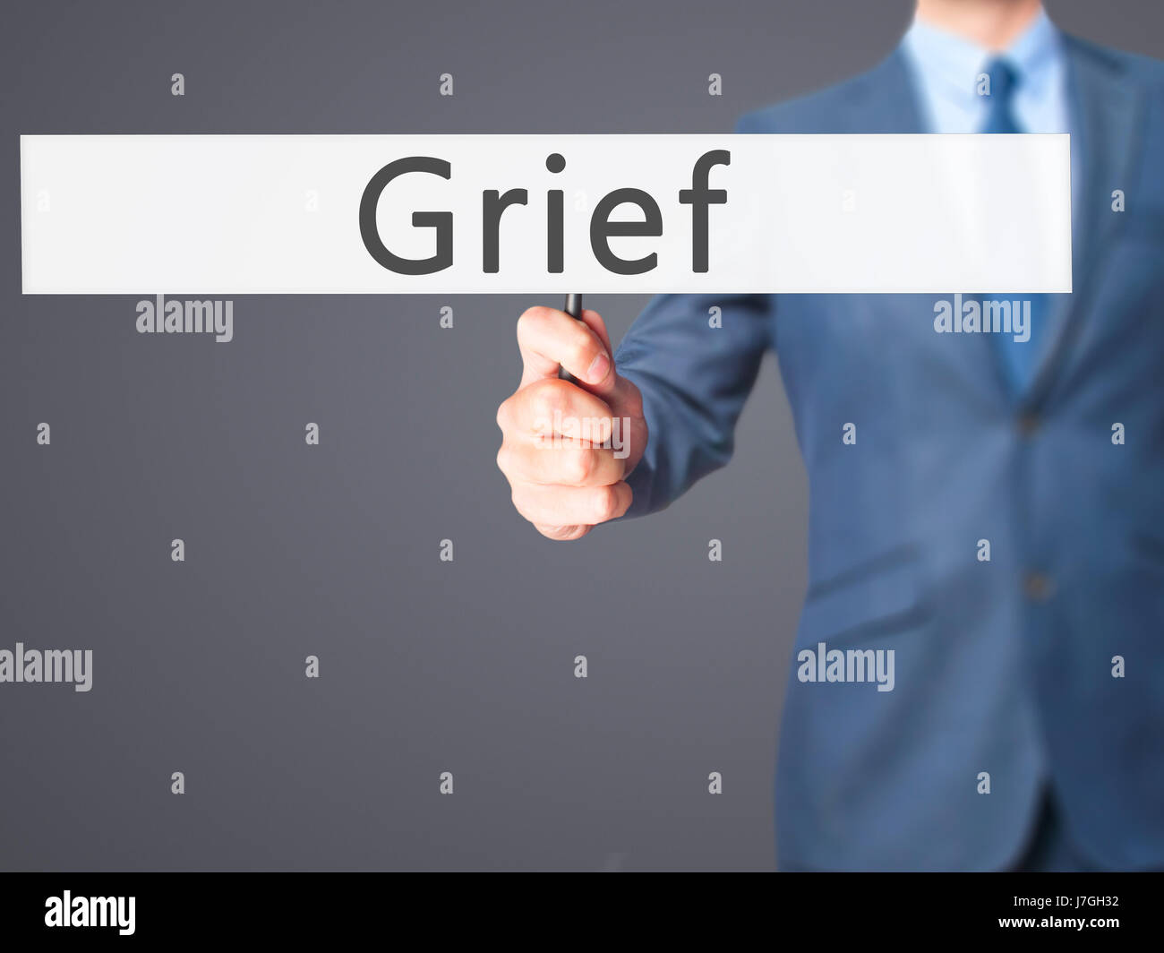 Grief - Businessman hand holding sign. Business, technology, internet ...