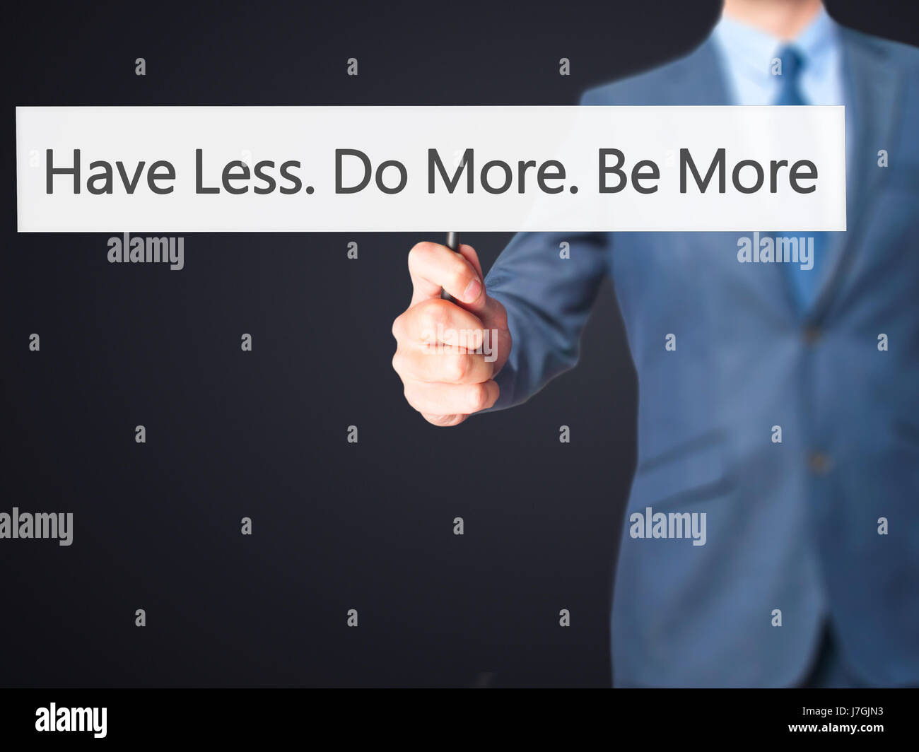 Have Less. Do More. Be More - Businessman hand holding sign. Business ...