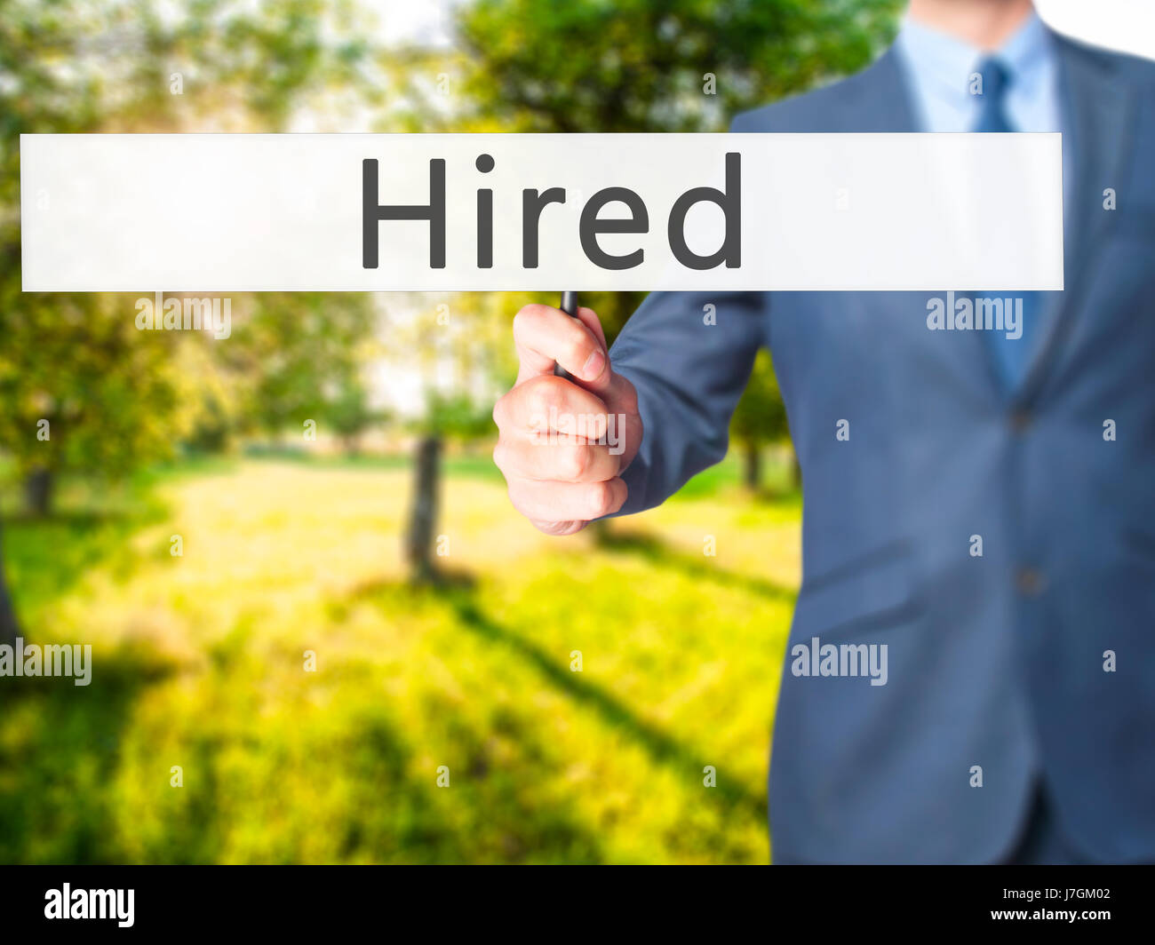 Hired - Businessman hand holding sign. Business, technology, internet ...