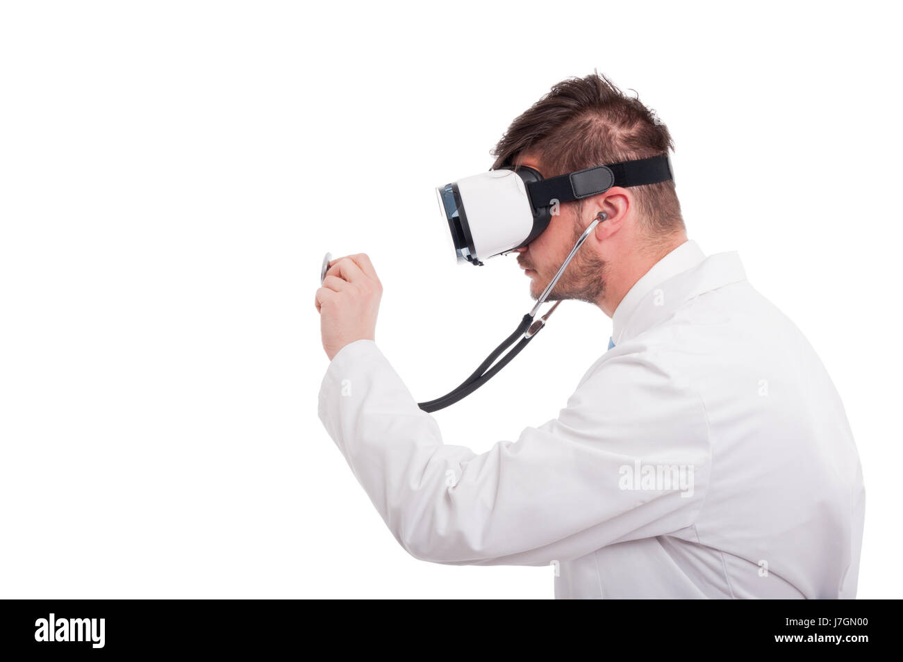 Side view of handsome medic with stethoscope and vr glasses on white ...