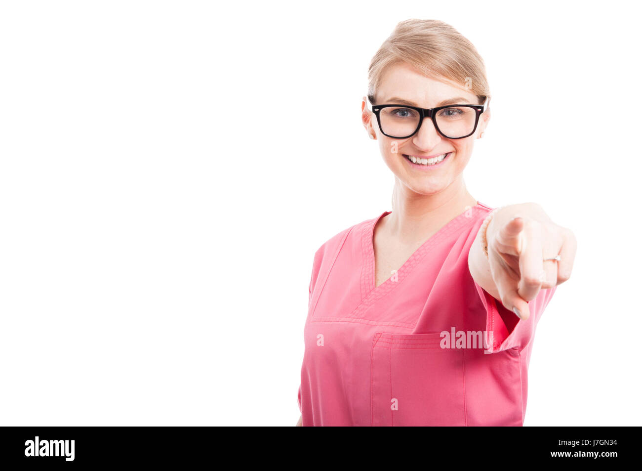 Portrait of young smiling female medical nurse pointing camera isolated ...