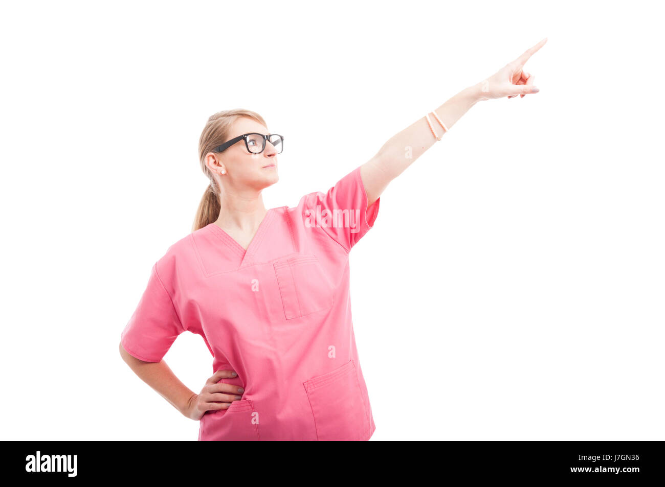 Low angle of female medical nurse pointing up isolated on white ...