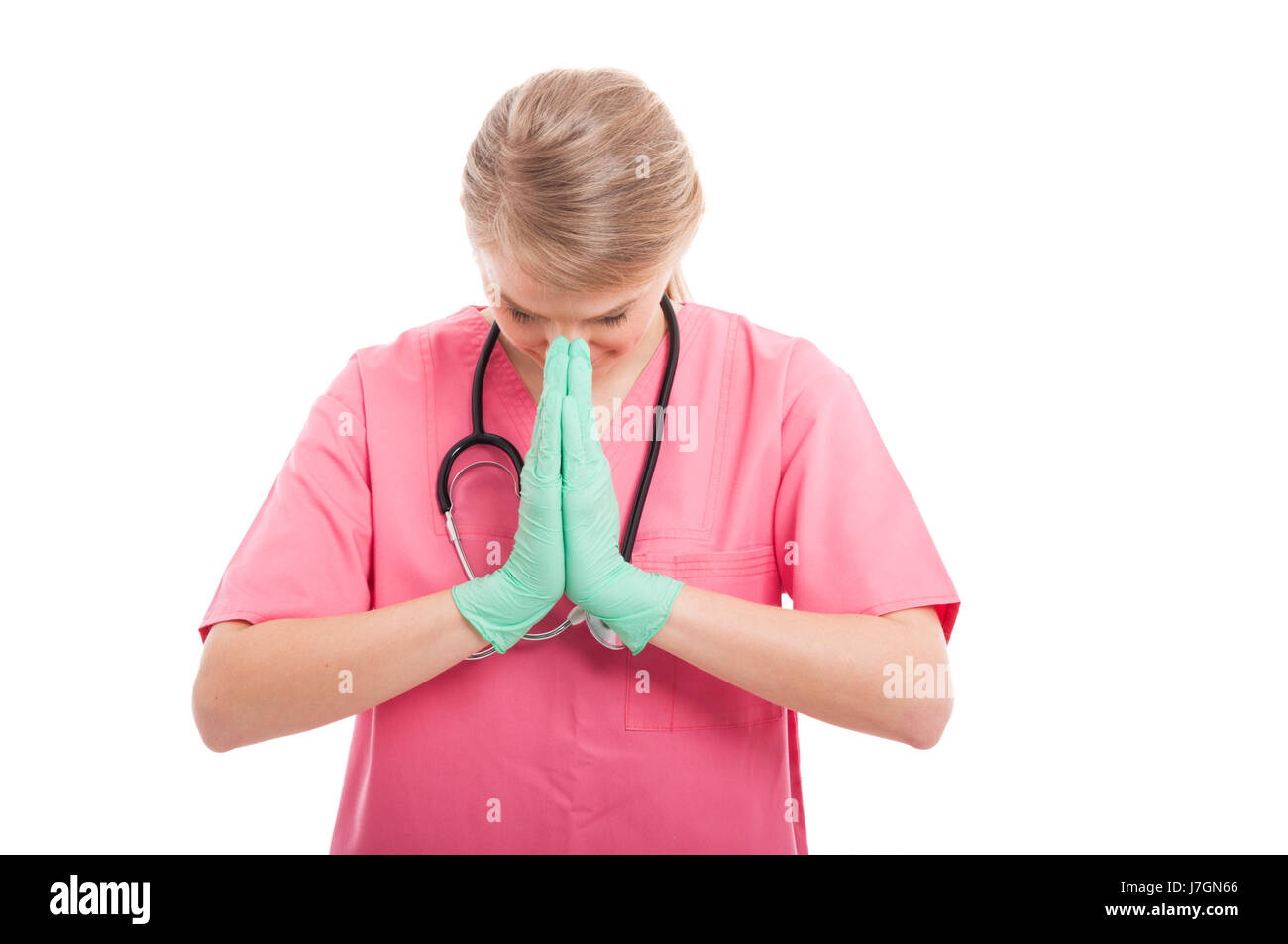 Blonde female nurse praying for something isolated on white background ...