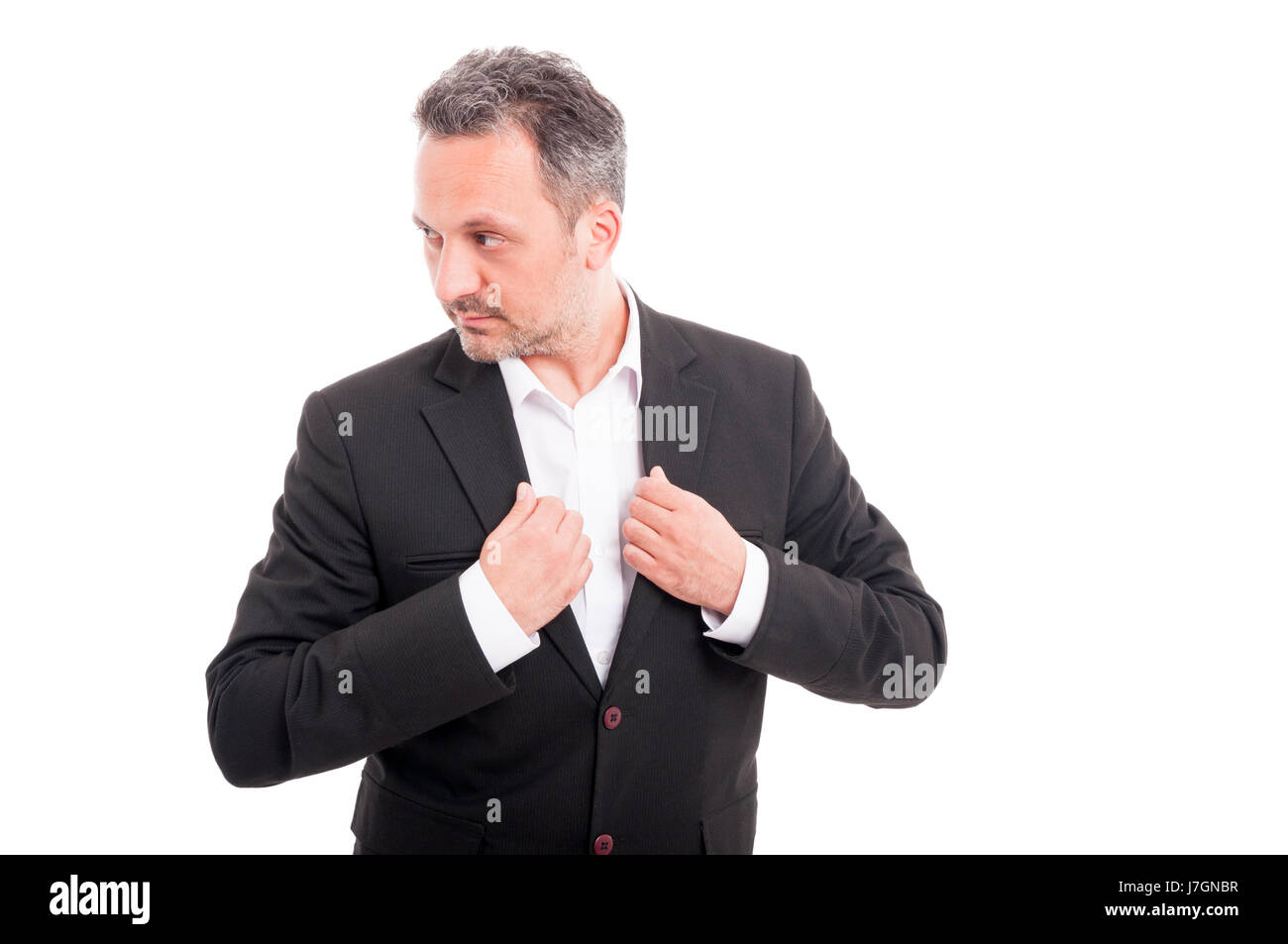 Relaxed successful man posing casually on white studio background with ...