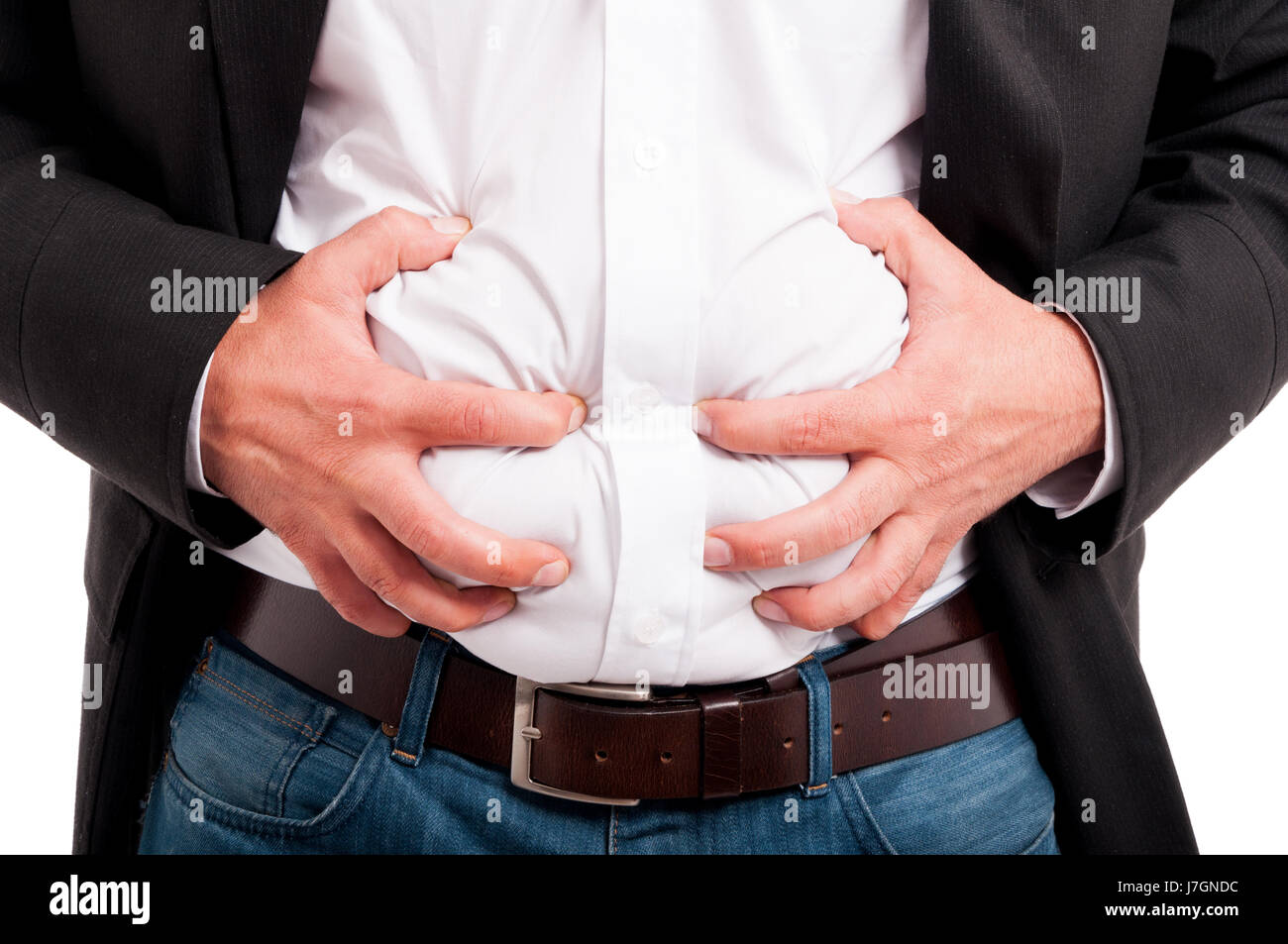 Man having indigestion after a business lunch as abdominal pain concept ...