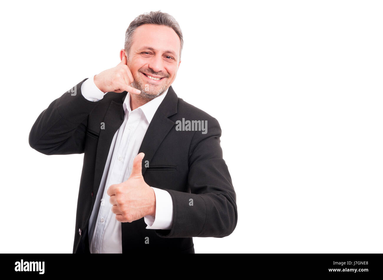 Cheerful smiling man making call me gesture with hand and showing thumb ...