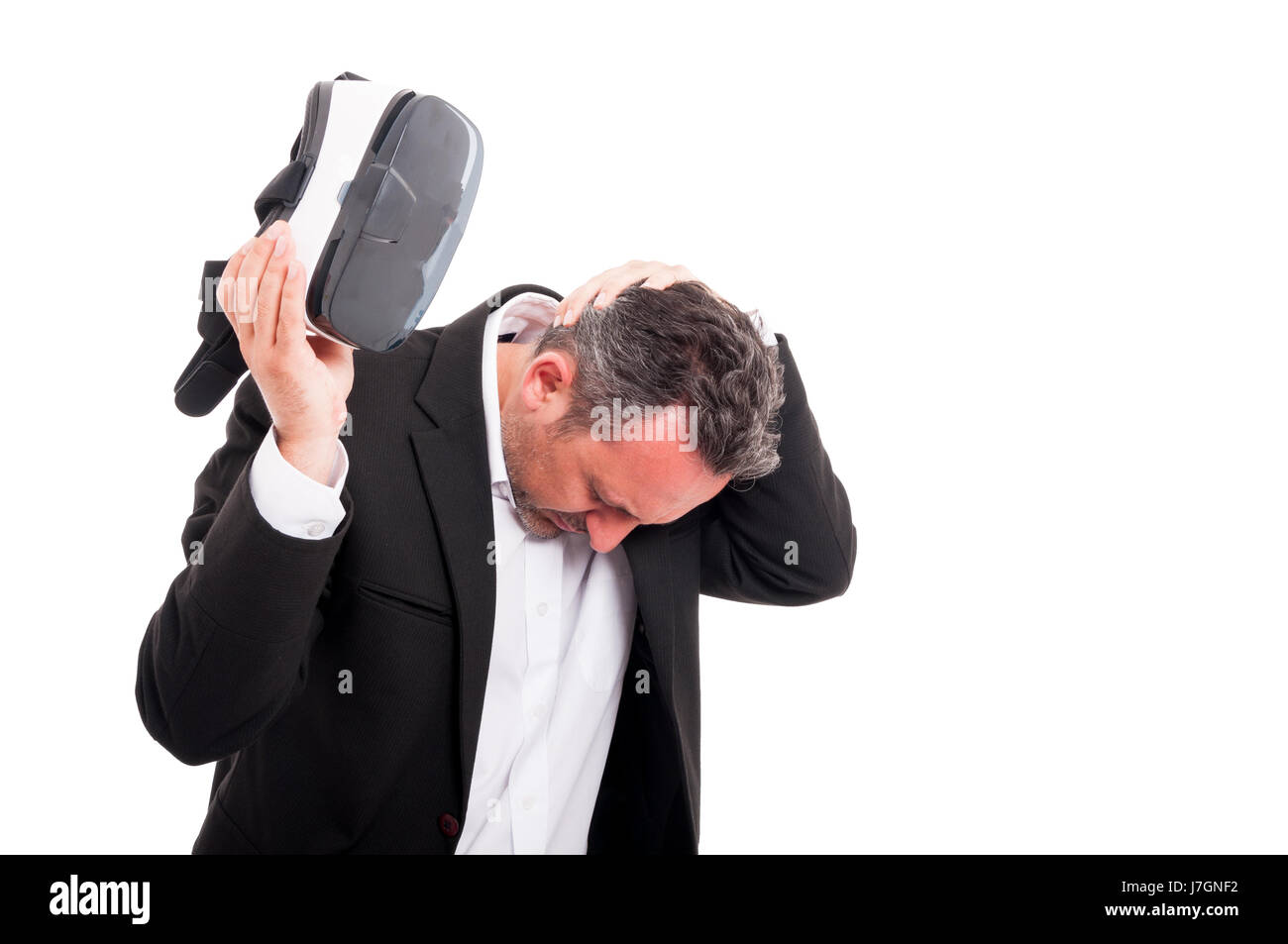 Man feeling tense after long vr simulation with modern headset on white ...