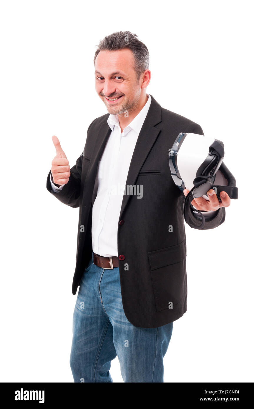 Cheerful male enjoy using virtyal reality goggles and doing thumb up ...