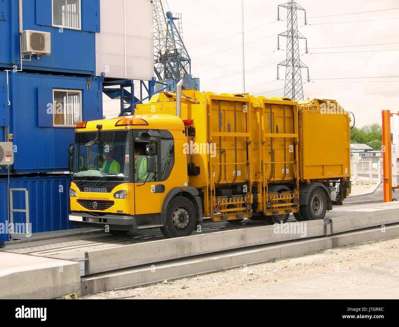Yellow refuse truck on a weighbridge at Southampton Docks, England ...