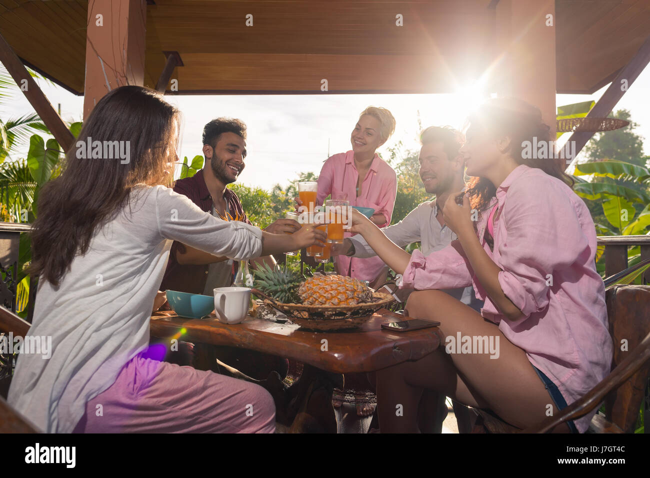 People On Summer Terrace Having Breakfast Together Toasting Juice ...