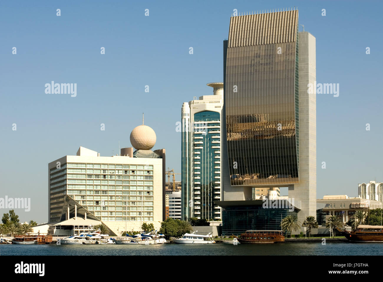 blue tower glass chalice tumbler buildings city town tree trees modern ...