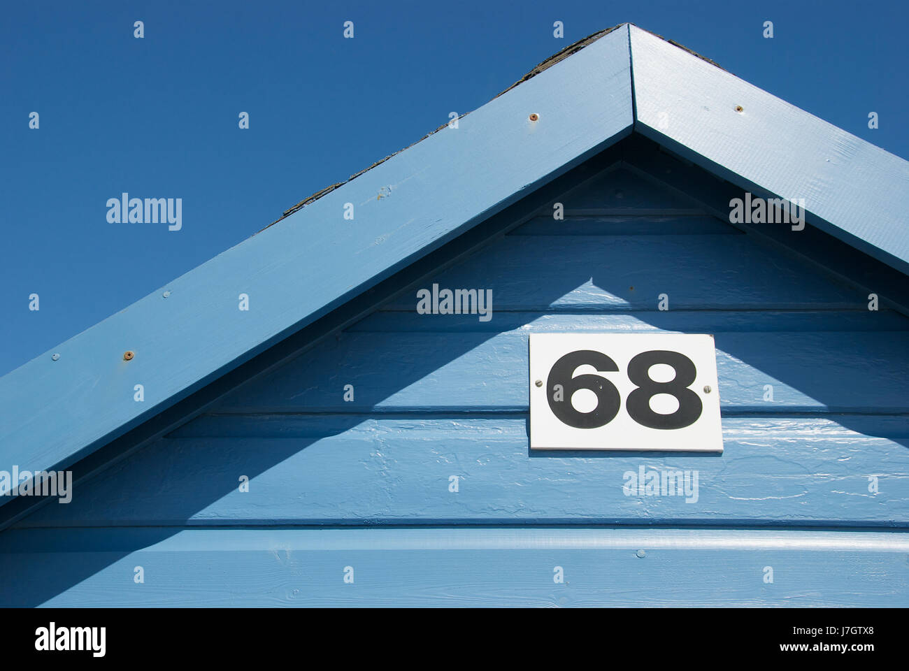 The number 68 on a beach hut Stock Photo - Alamy